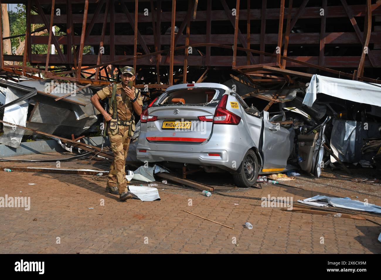 View of damaged vehicles at a petrol pump after an advertising hoarding ...