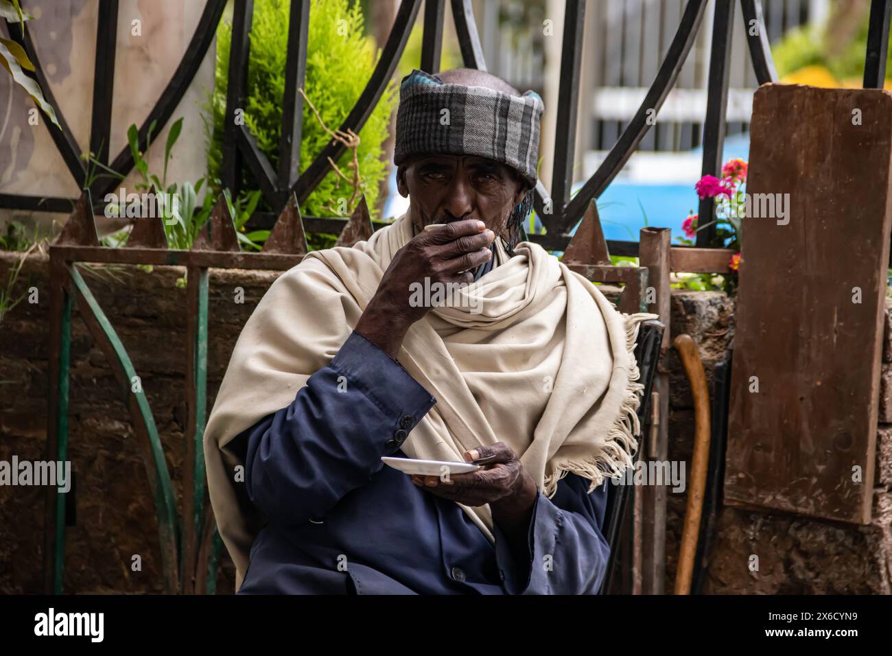 Elderly man traditionally dressed drinking Ethiopian genuine coffee in ...