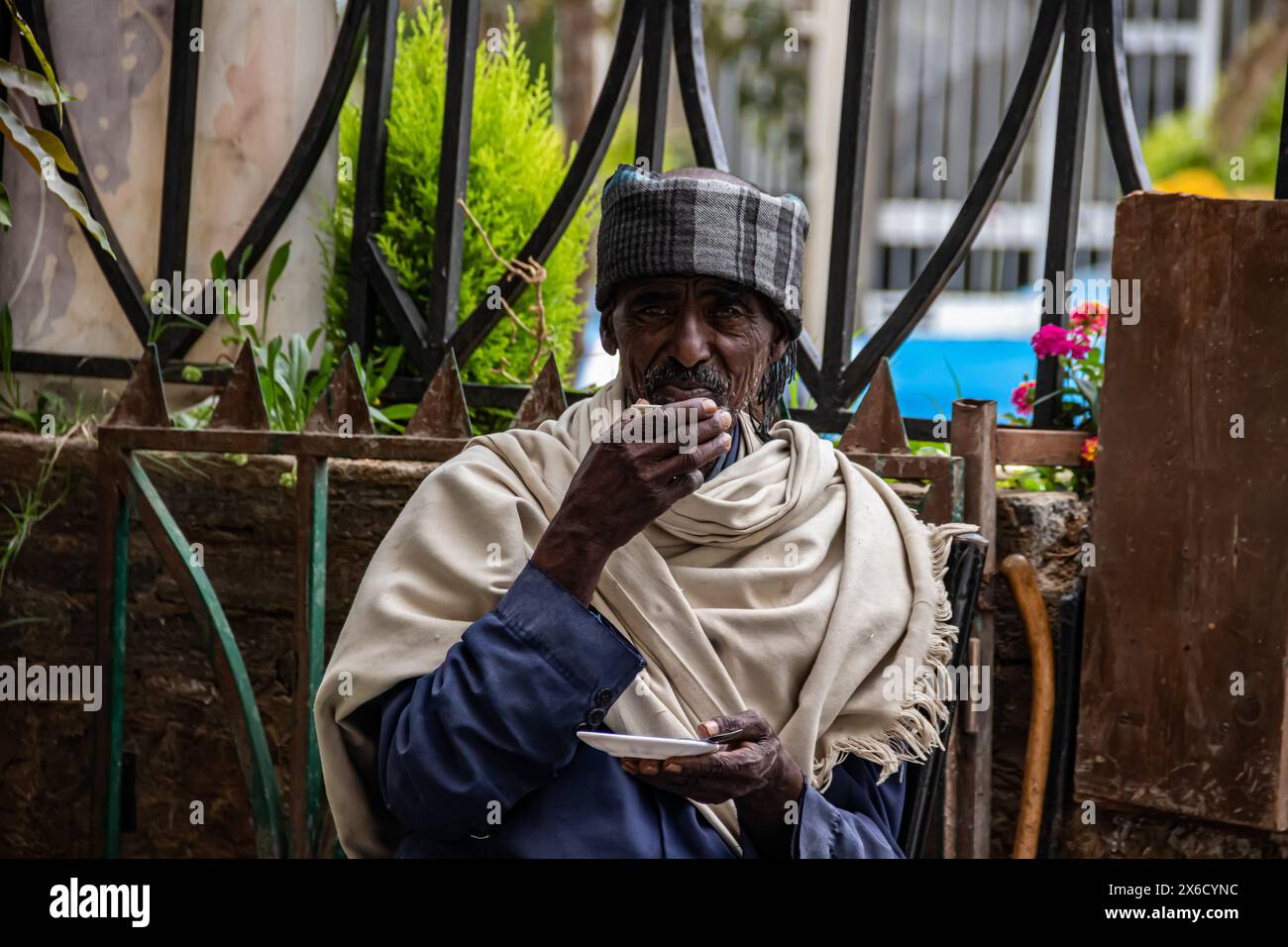 Elderly man traditionally dressed drinking Ethiopian genuine coffee in ...