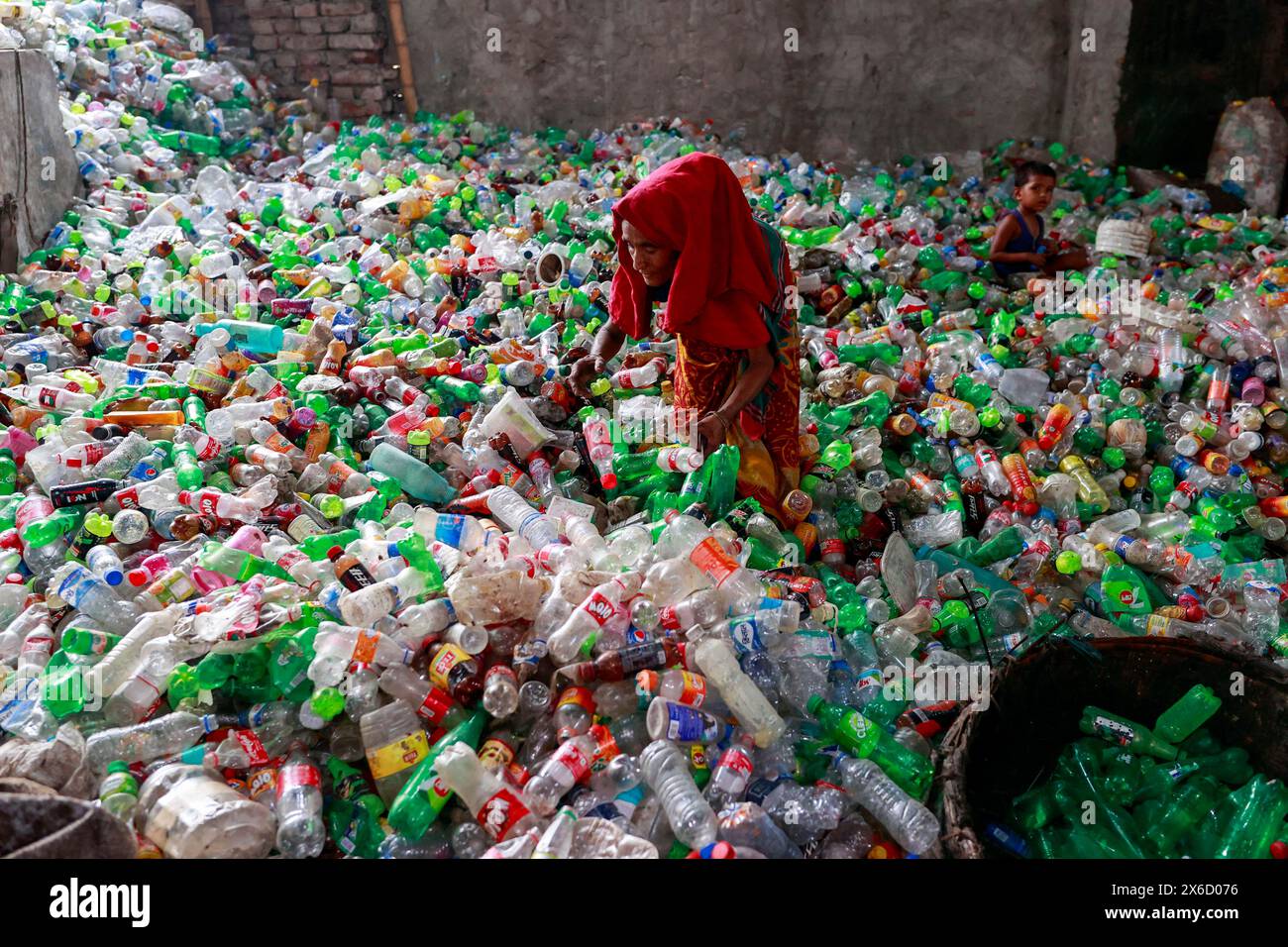 Dhaka, Bangladesh, May 14, 2024. A Bangladeshi woman works in a plastic bottle recycling factory ...