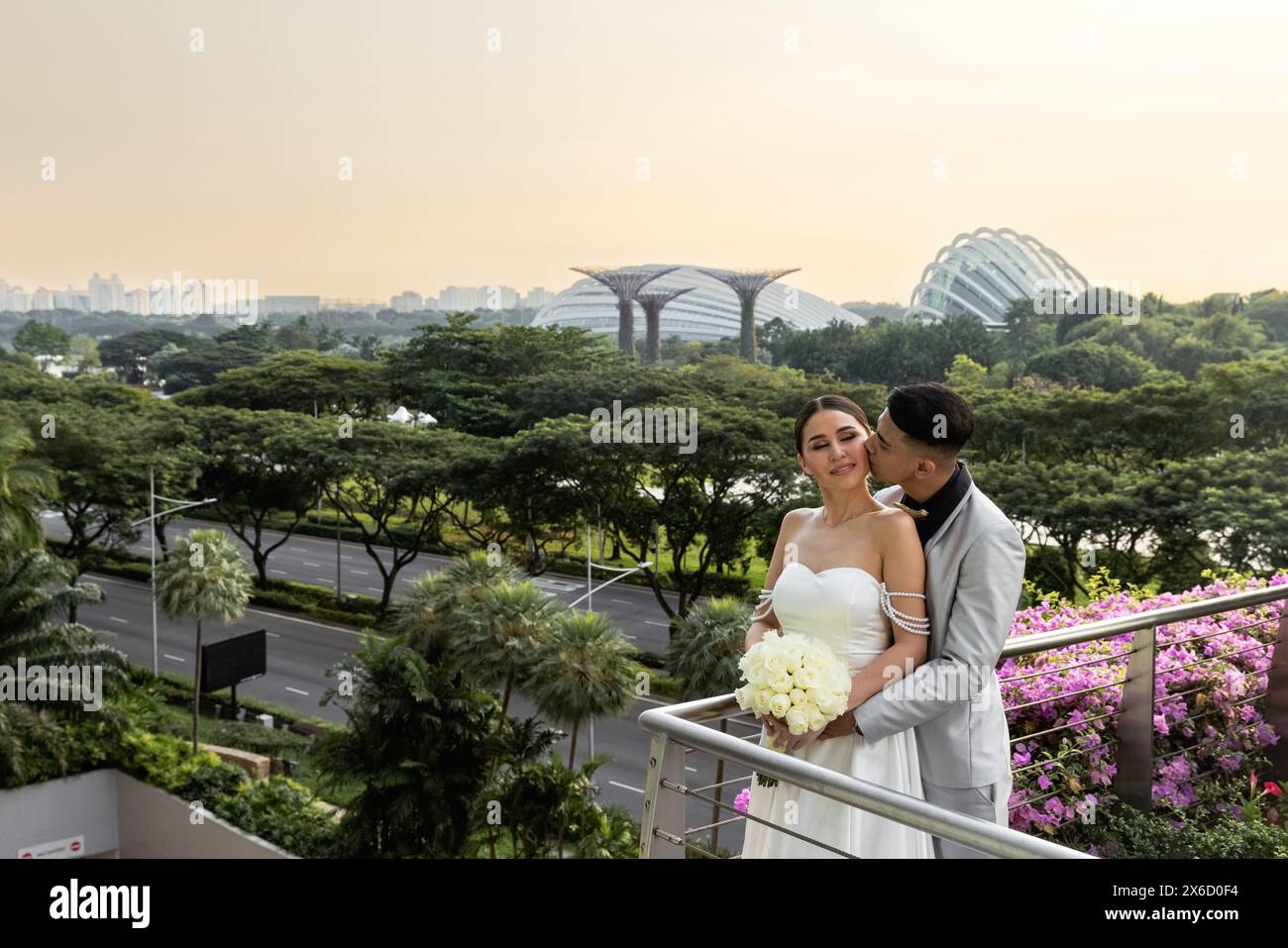 A beautiful wedding couple is kissing with Gardens by the Bay in ...