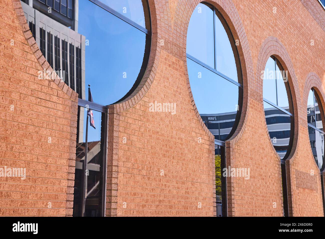 Ruond Windows Reflecting Modern Facade in Urban Setting, Eye-Level View ...