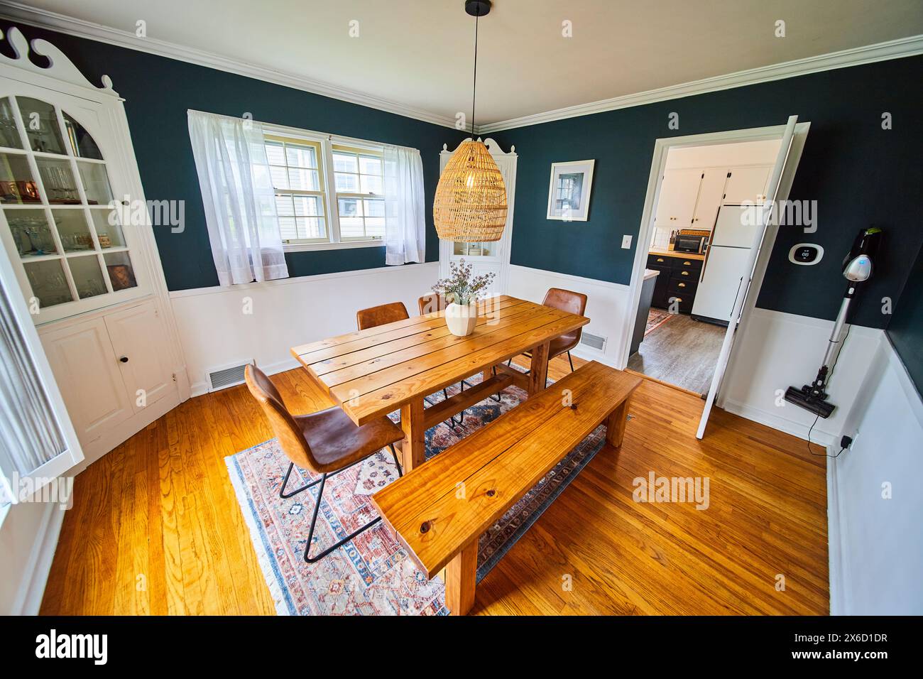 Modern Rustic Dining Room with Navy Accent Wall and Wicker Light Stock ...