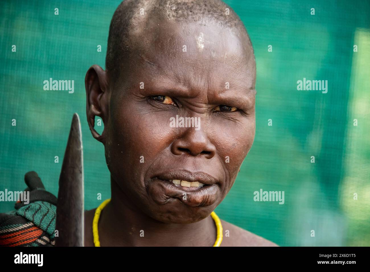 African woman, member of Mursi tribe in Ethiopia. Mursi women are ...