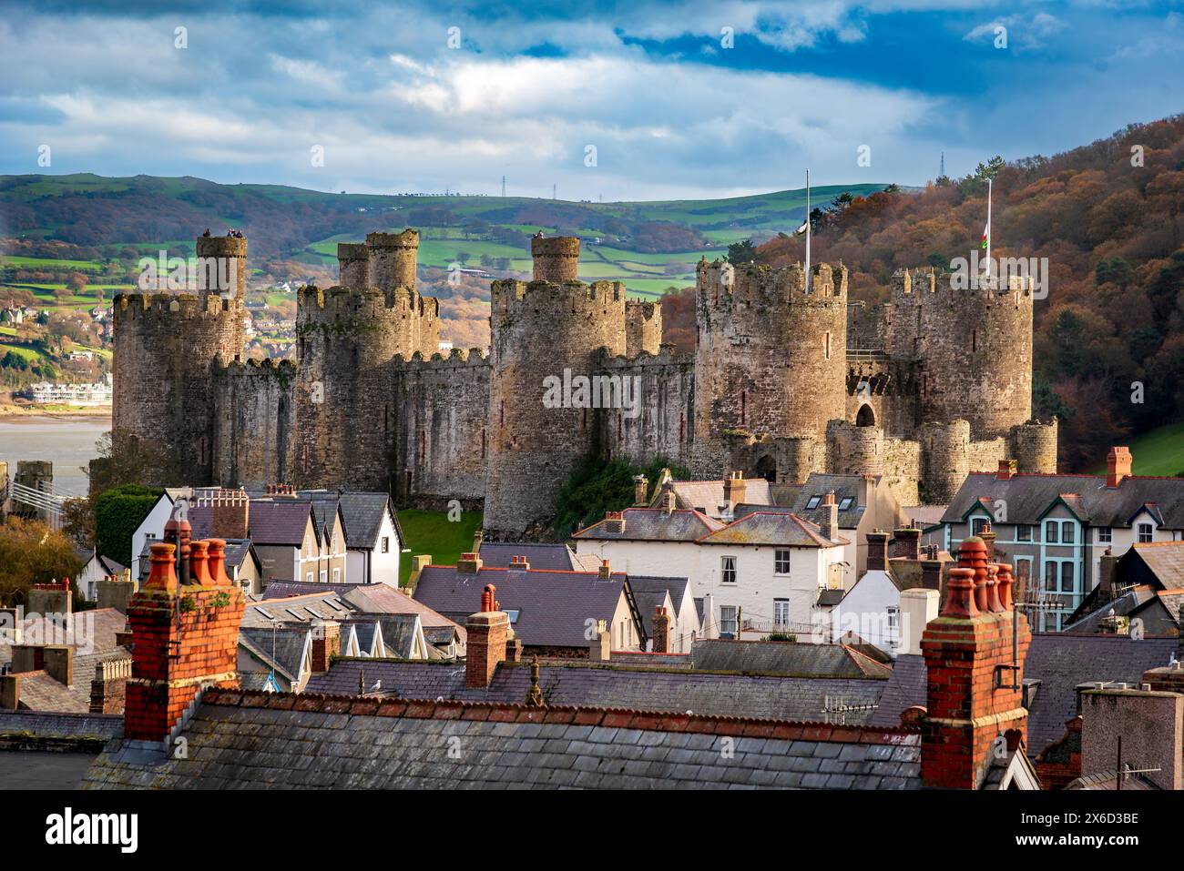 Conwy castle seen across the rooftops of the Welsh walled town Stock ...