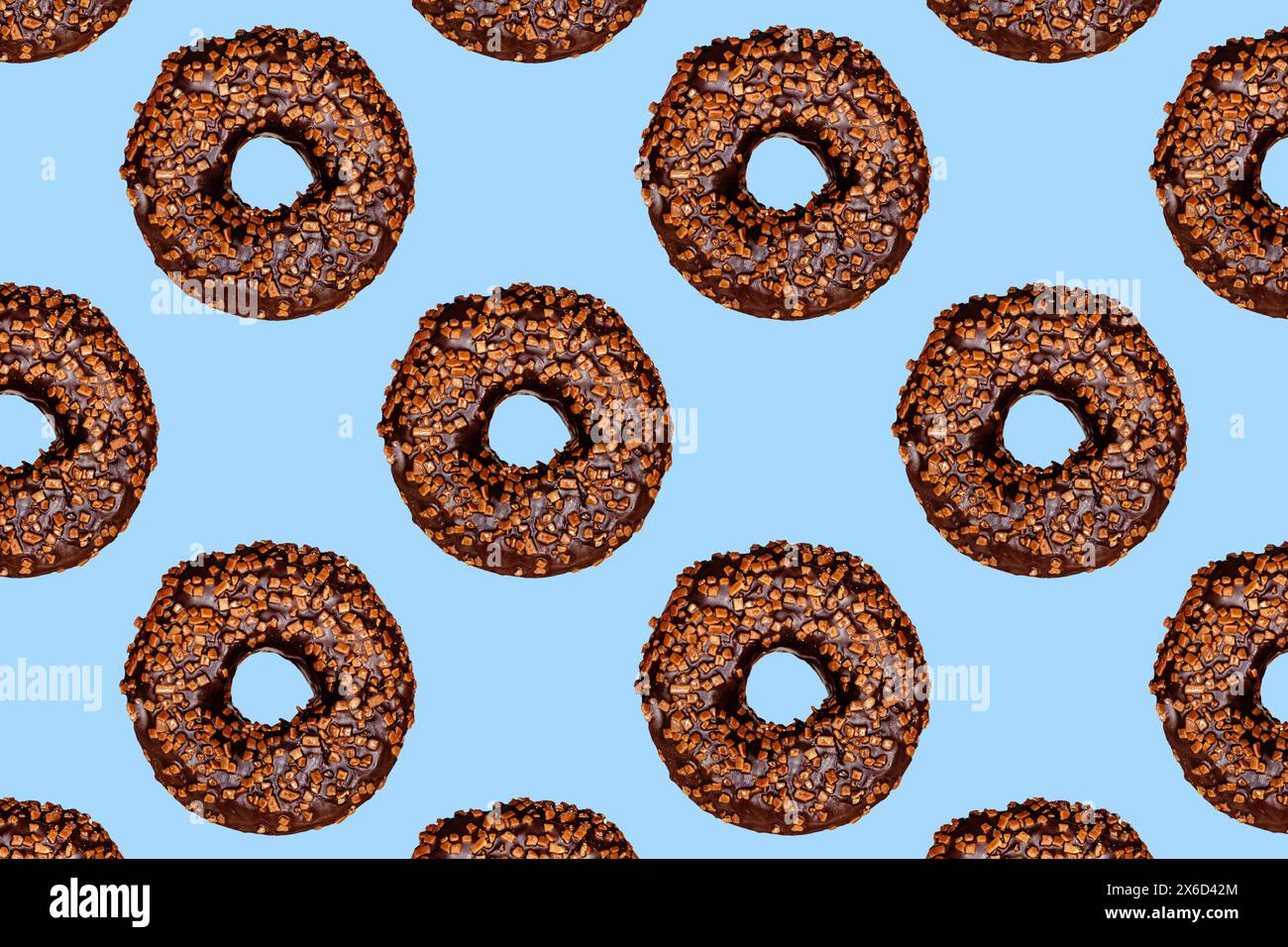 Creative pattern of chocolate donuts with holes on a blue background ...