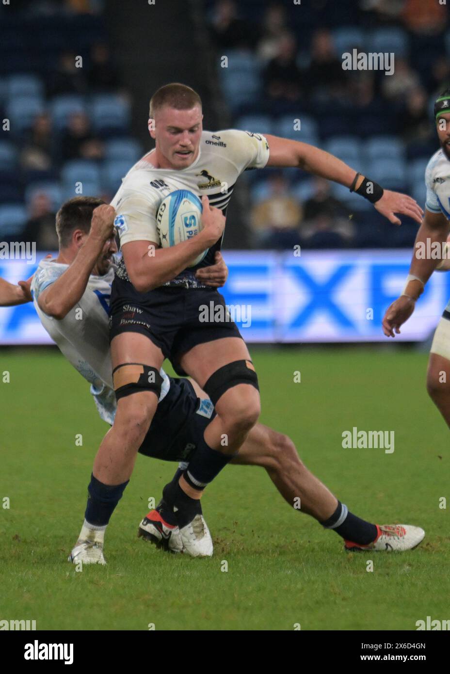 Charlie Cale (front) of ACT Brumbies and Jake Gordon (back) of NSW ...