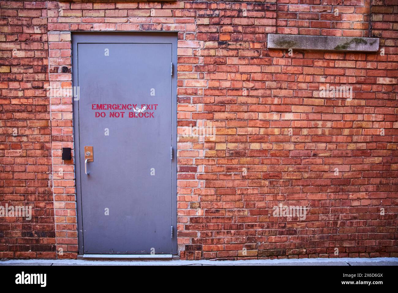 Emergency Exit on Textured Brick Wall, Modern Metal Door, Eye-Level ...