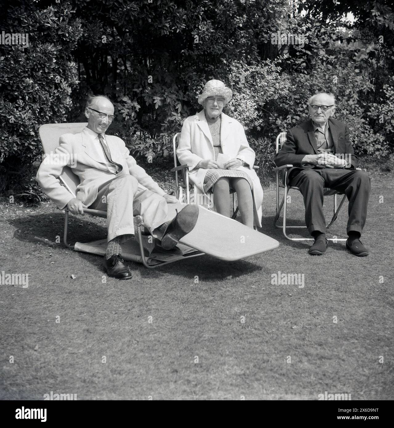 1970s, historical, three elderly people sitting in a back garden, an ...