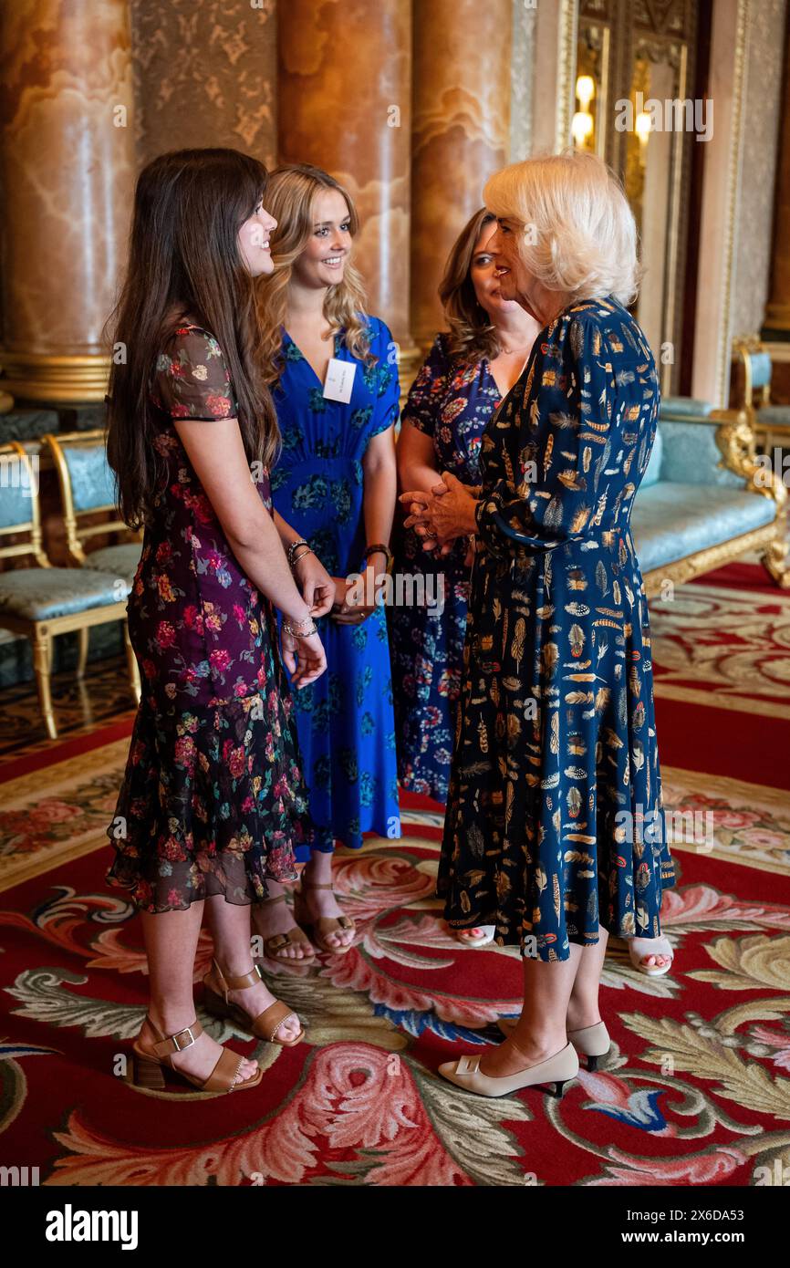 Queen Camilla talks with the artist's family at the unveiling of artist ...