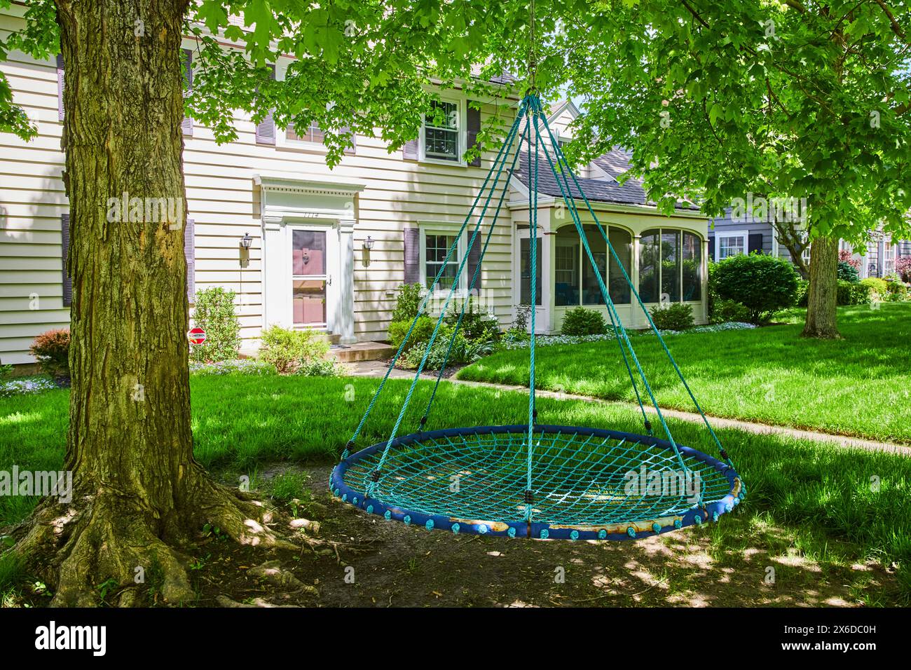 Suburban Home with Tree Swing and Lush Garden, Eye-Level View Stock ...
