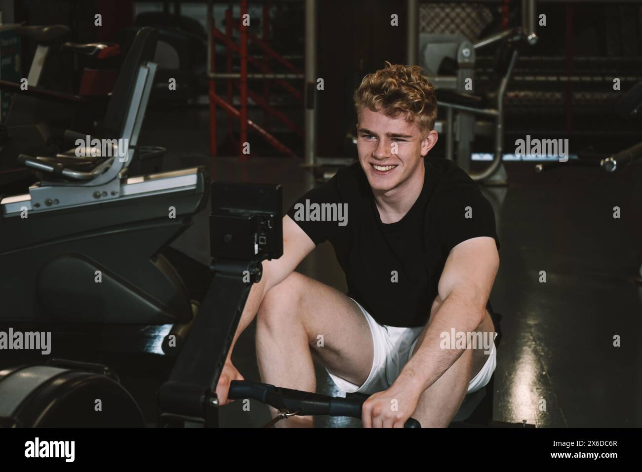 Sportsman is working out on a rowing machine hi-res stock photography ...