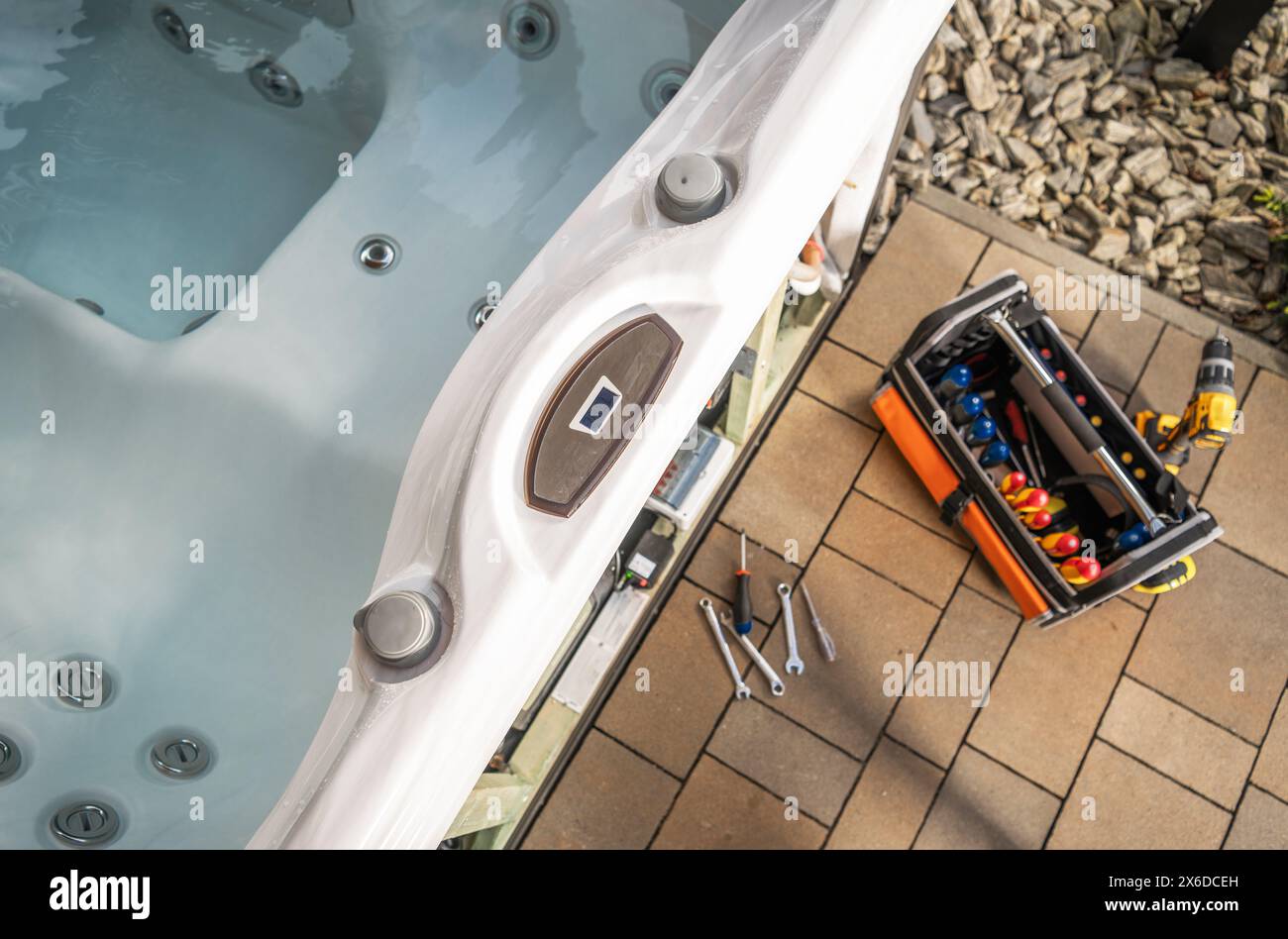Tools scattered on a hot tub. Garden SPA repair theme Stock Photo - Alamy