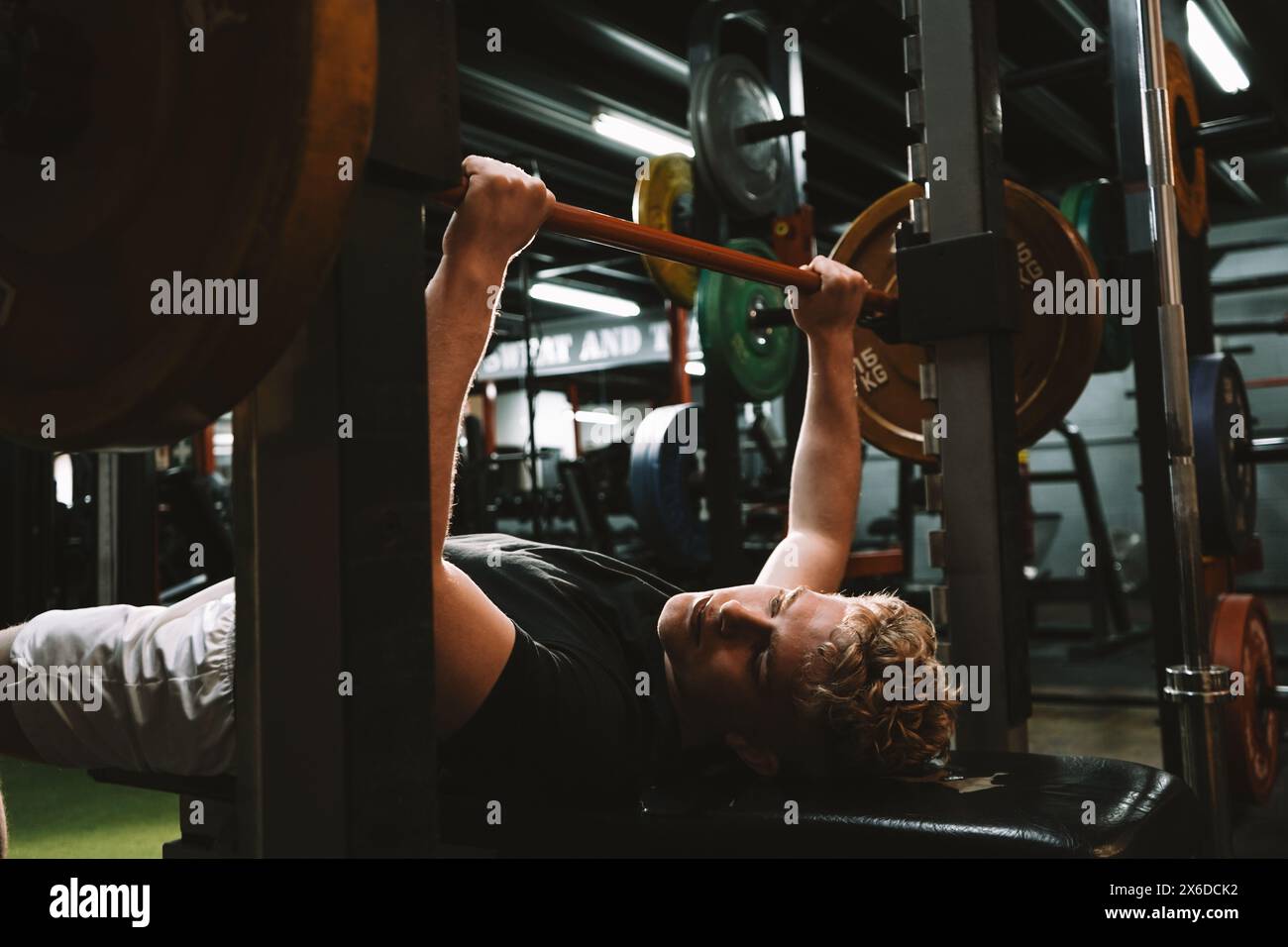 Strong athletic man doing bench press at the gym Stock Photo - Alamy