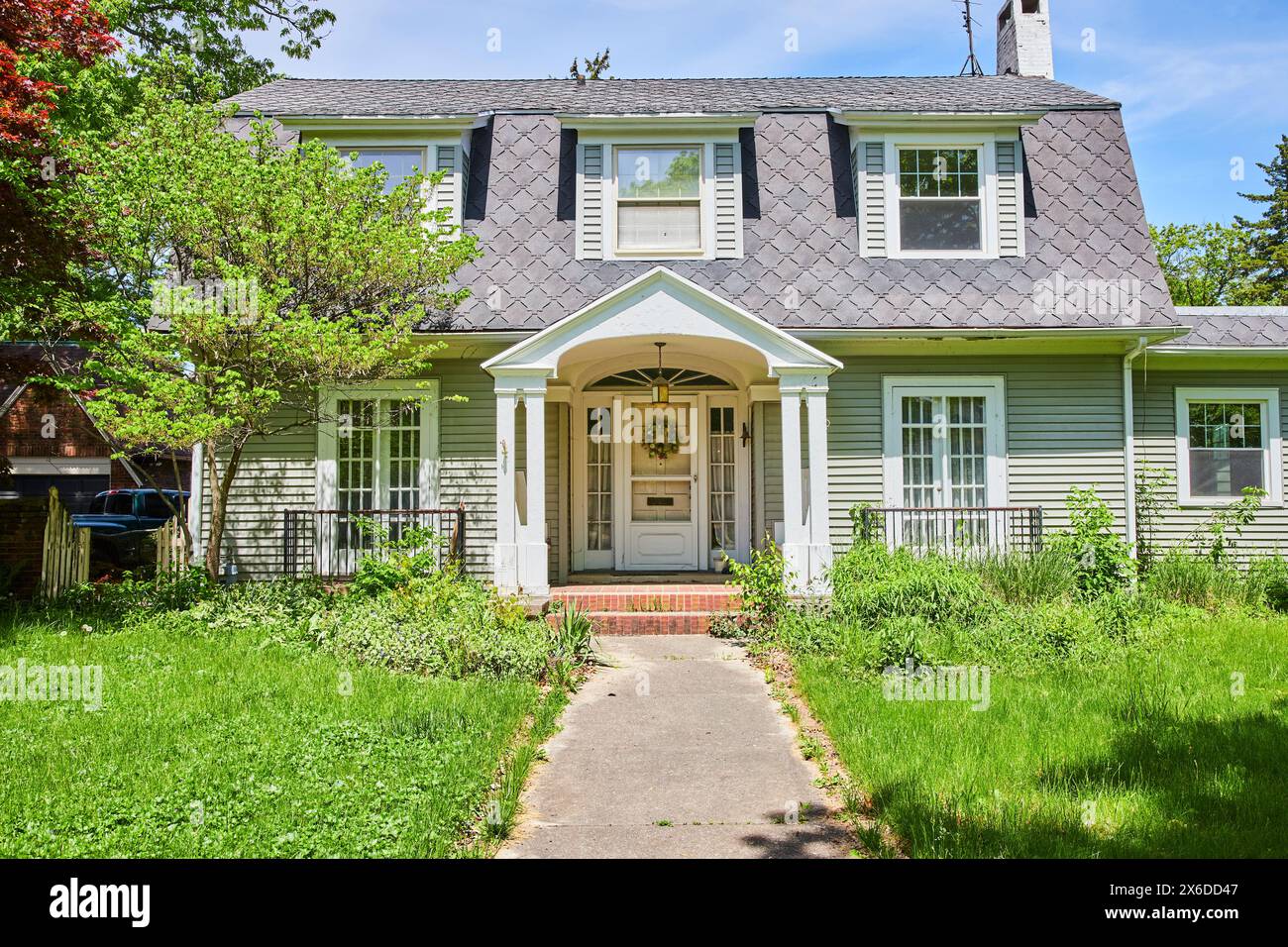 Classical Suburban Home in Lush Greenery, Eye-Level View Stock Photo ...
