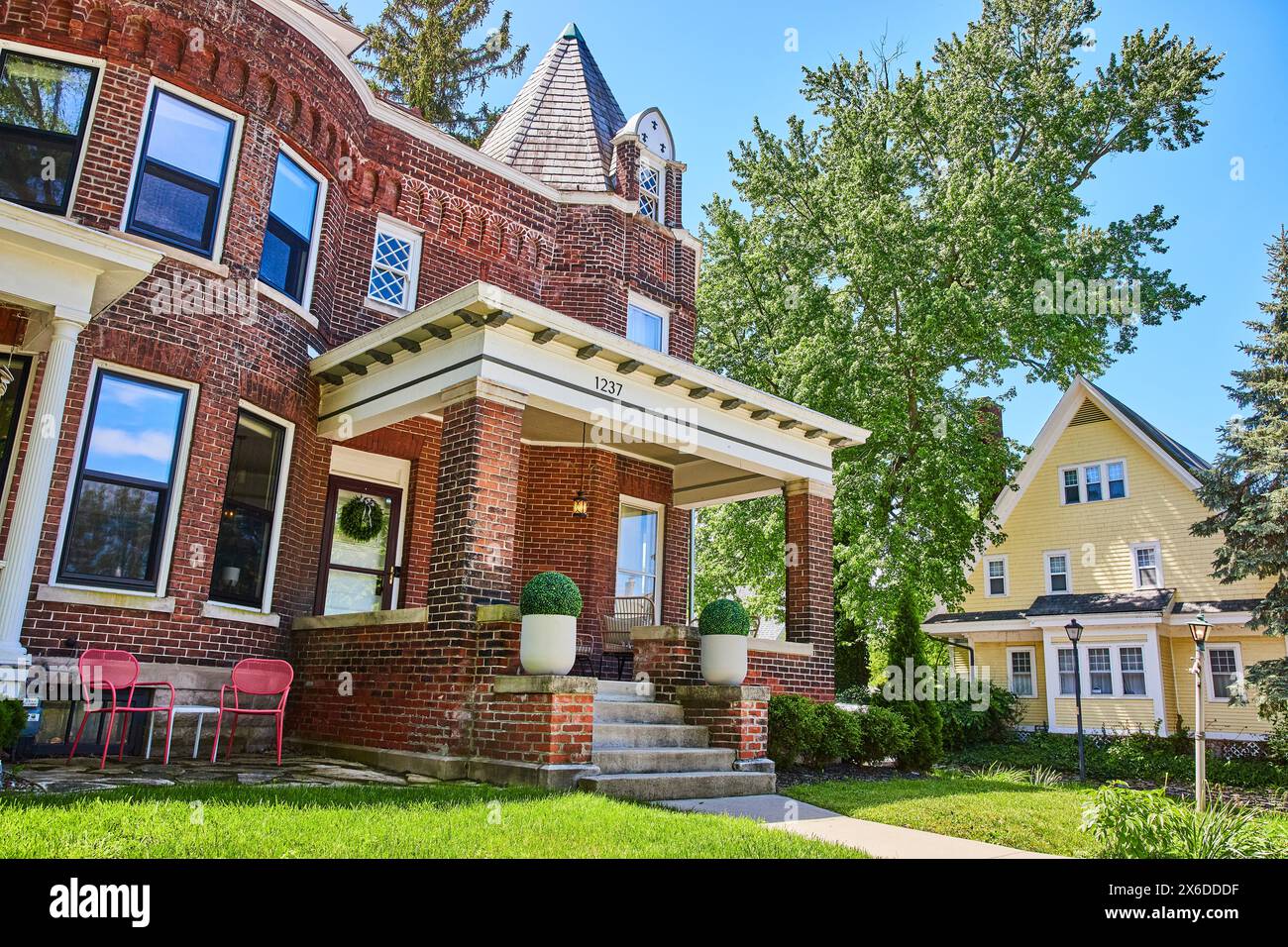 Traditional Red Brick House with Turret in Suburban Fort Wayne Stock ...