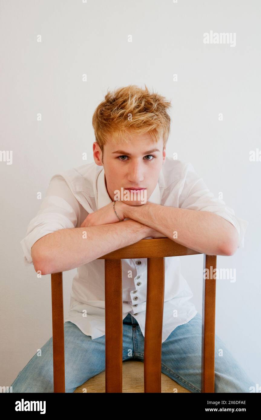 Young man sitting astride hi-res stock photography and images - Alamy