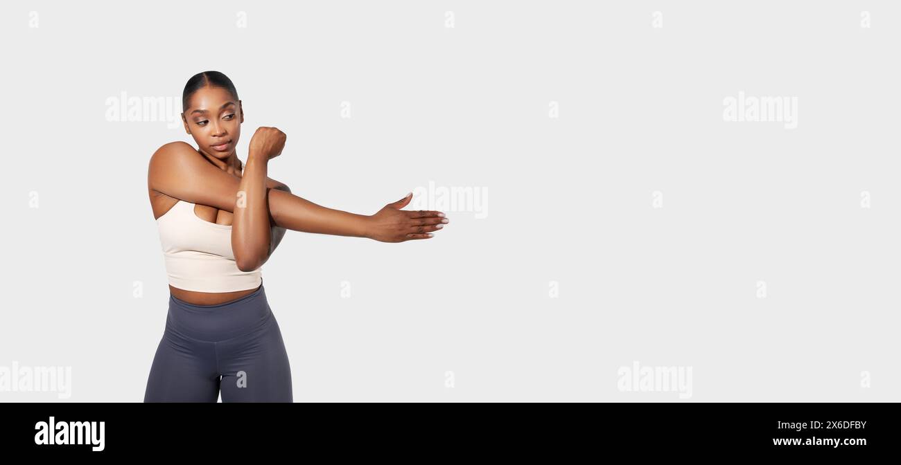 Woman Flexing Arm in Front of White Background Stock Photo - Alamy