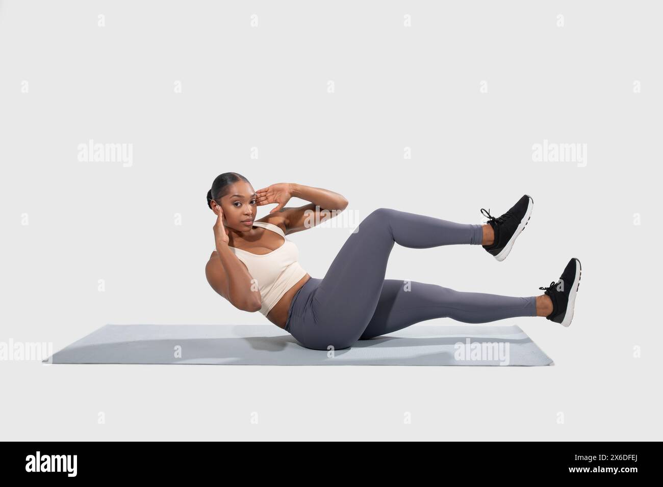 Woman Performing Exercise on Mat Over White Background Stock Photo - Alamy
