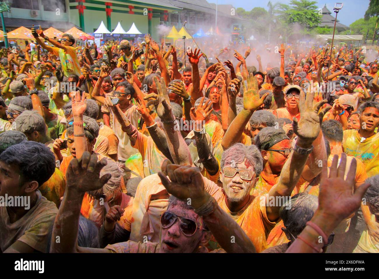 A group of energetic young men and girls jumped up expressing their joy ...