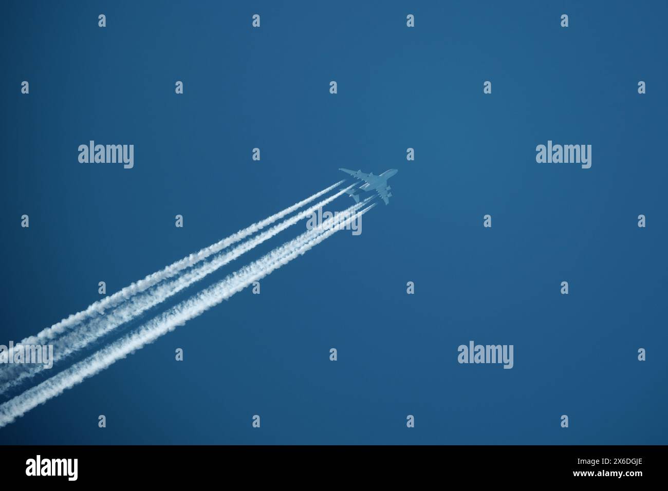 Airplane trails in the blue sky. Airplane trail on blue sky Stock Photo ...