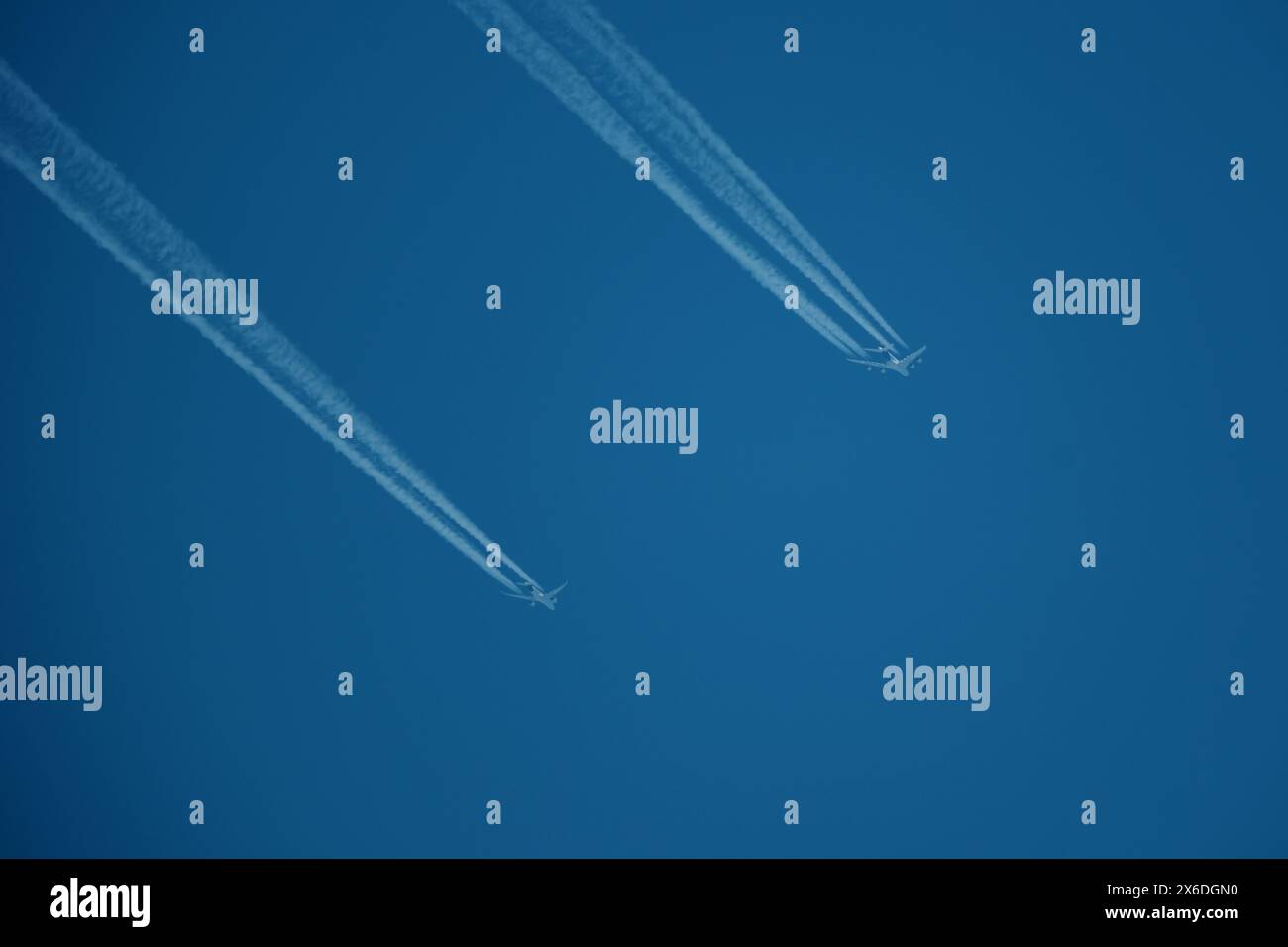 two parallel airplane tracks in the blue sky, contrails Stock Photo - Alamy