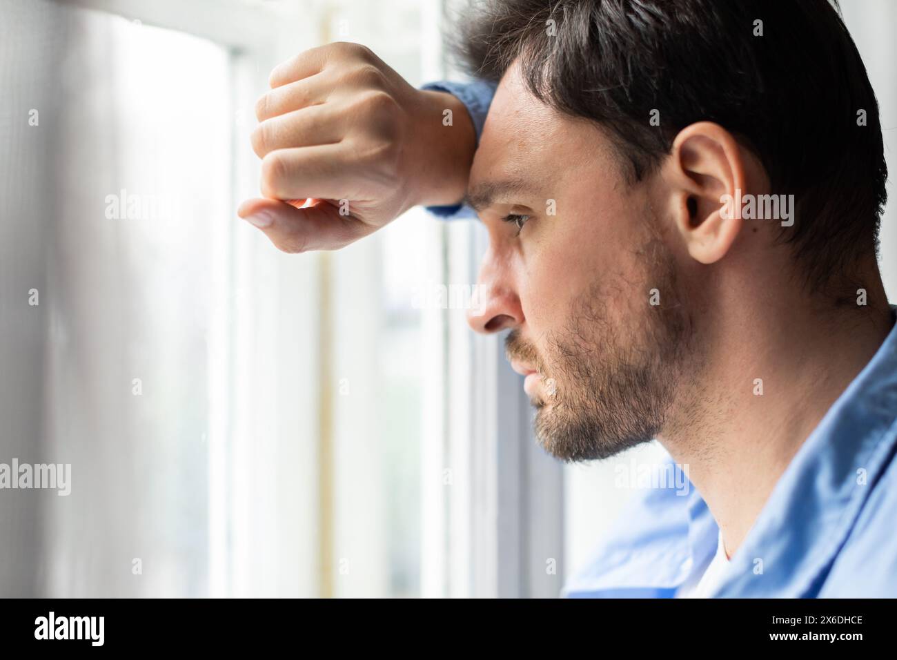 Pensive Man Gazing Out of a Window During Daylight Hours Stock Photo ...