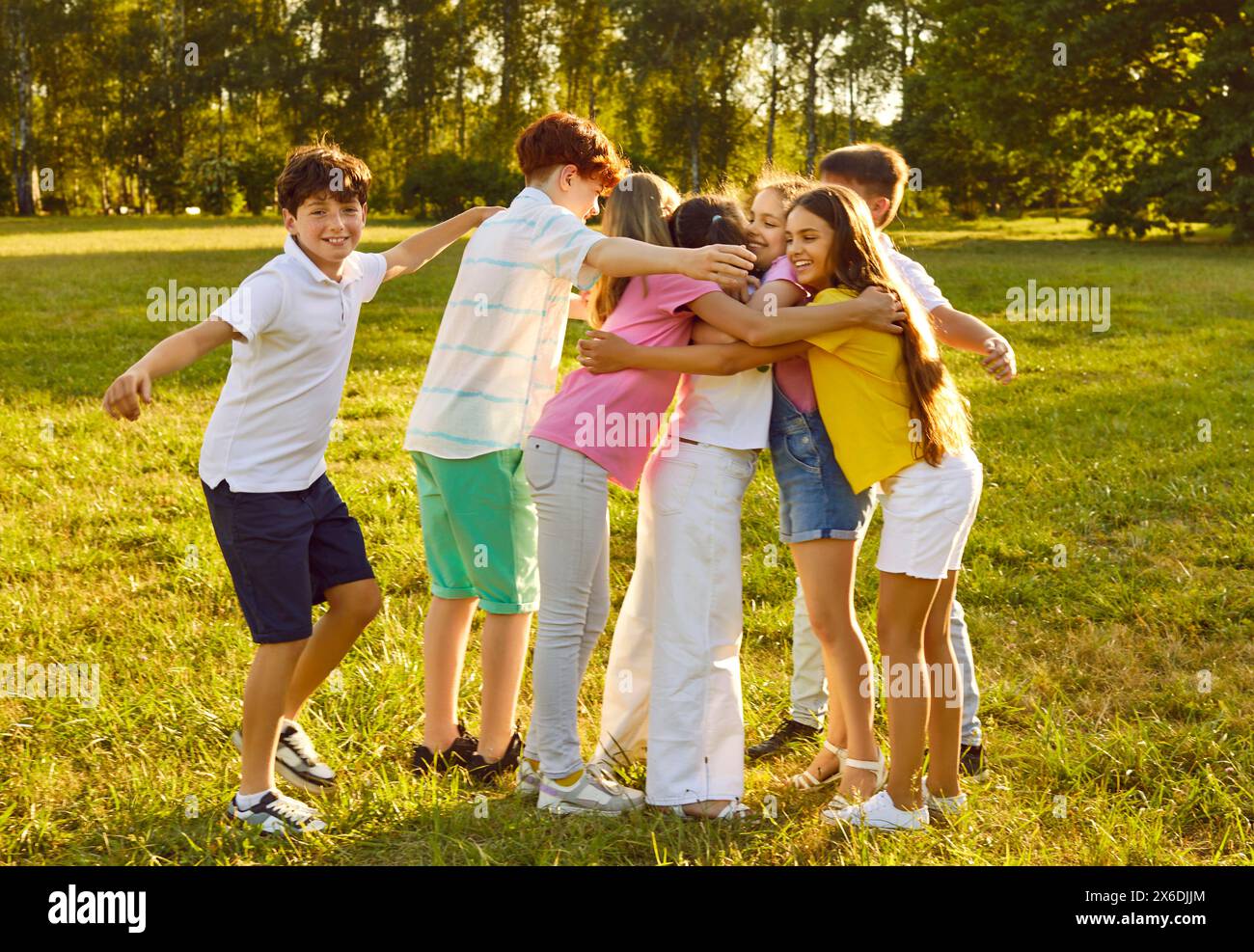 Funny happy overjoyed group of kids friends having fun in nature on ...