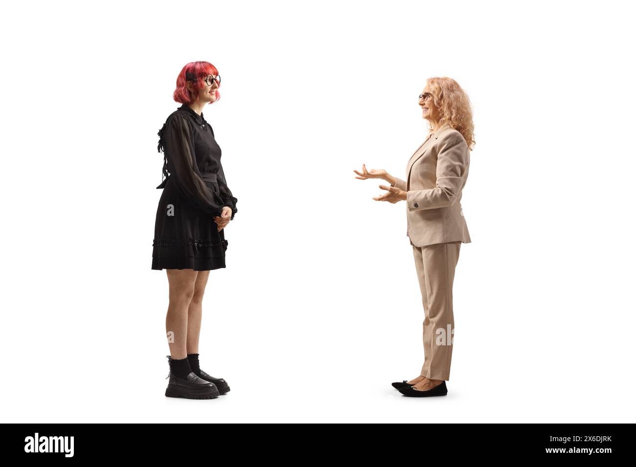 Full length profile shot of a young woman listening to another woman ...