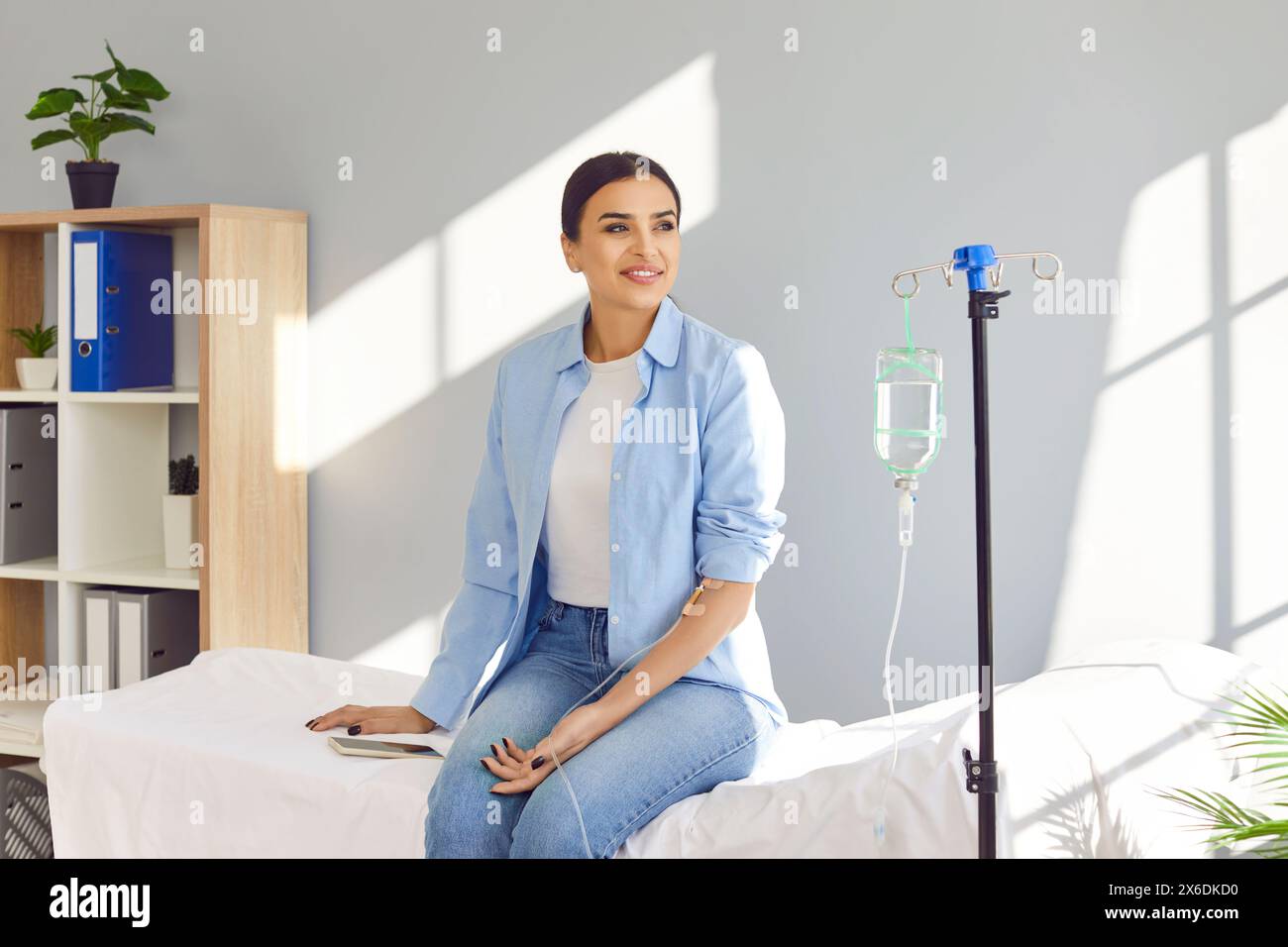 Woman receiving IV drip infusion and vitamin injection therapy in her ...