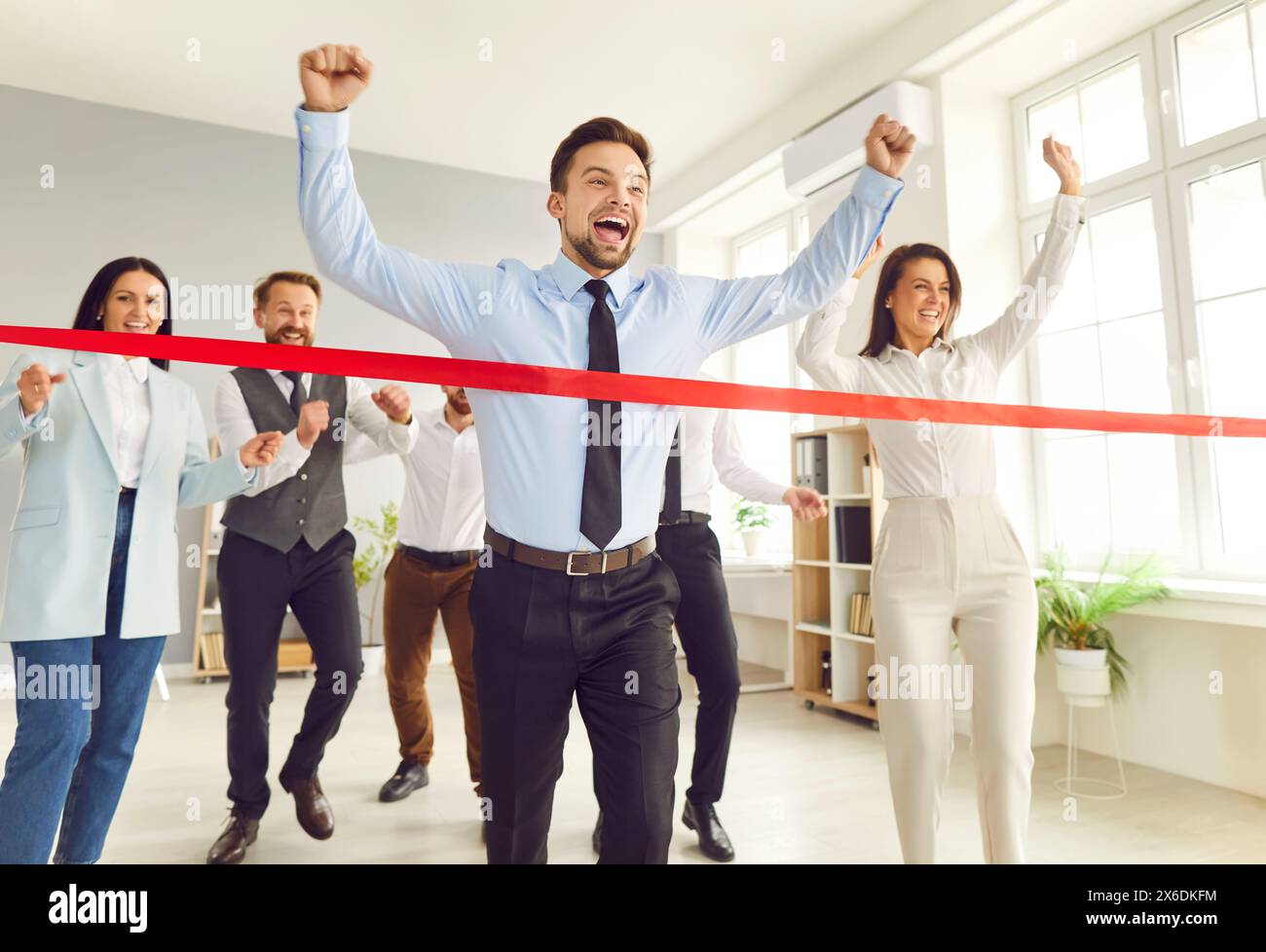 Businessman Crossing The Red Finish Line In Office Stock Photo - Alamy