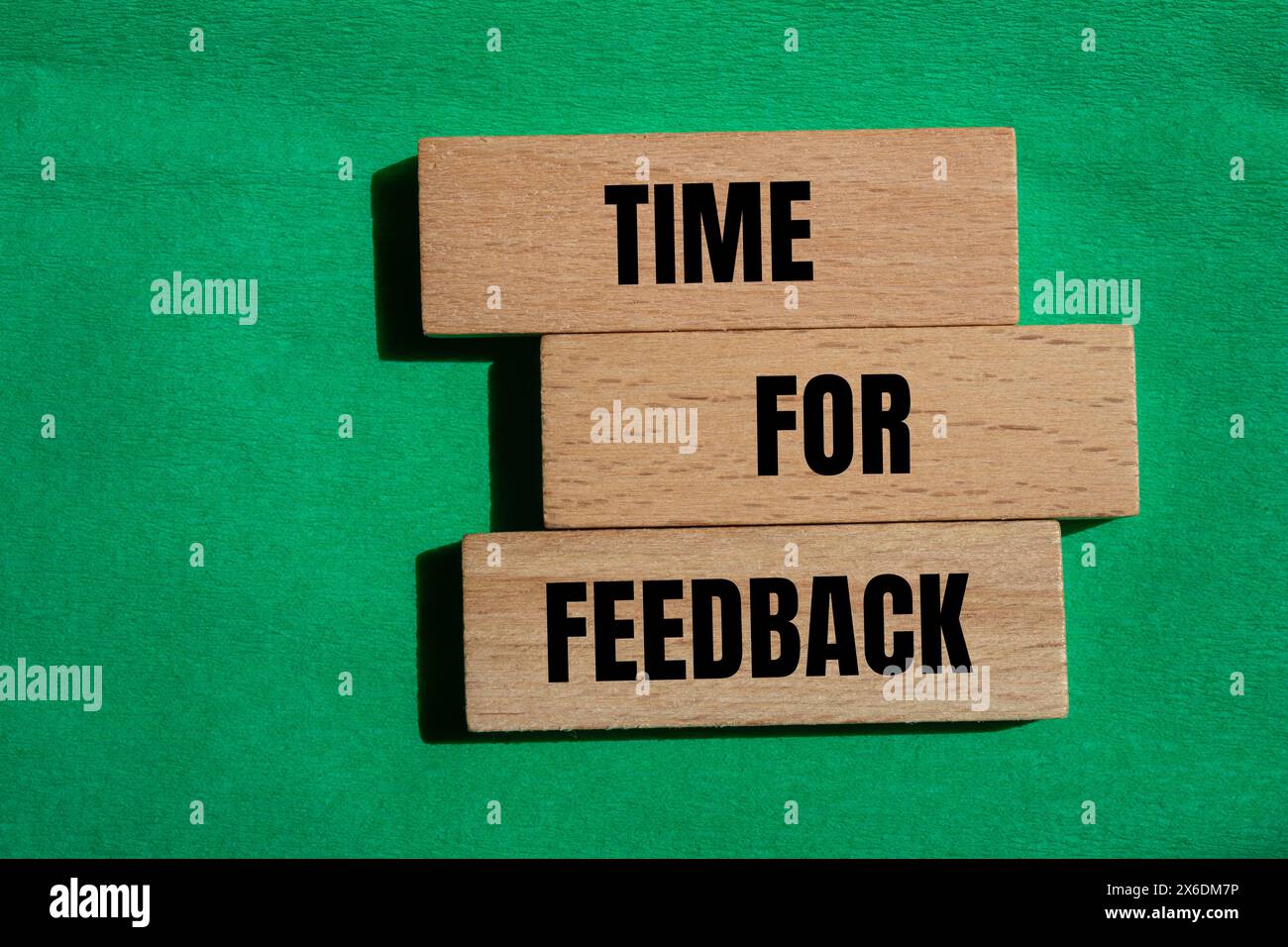 Time for feedback words written on wooden blocks with green background ...