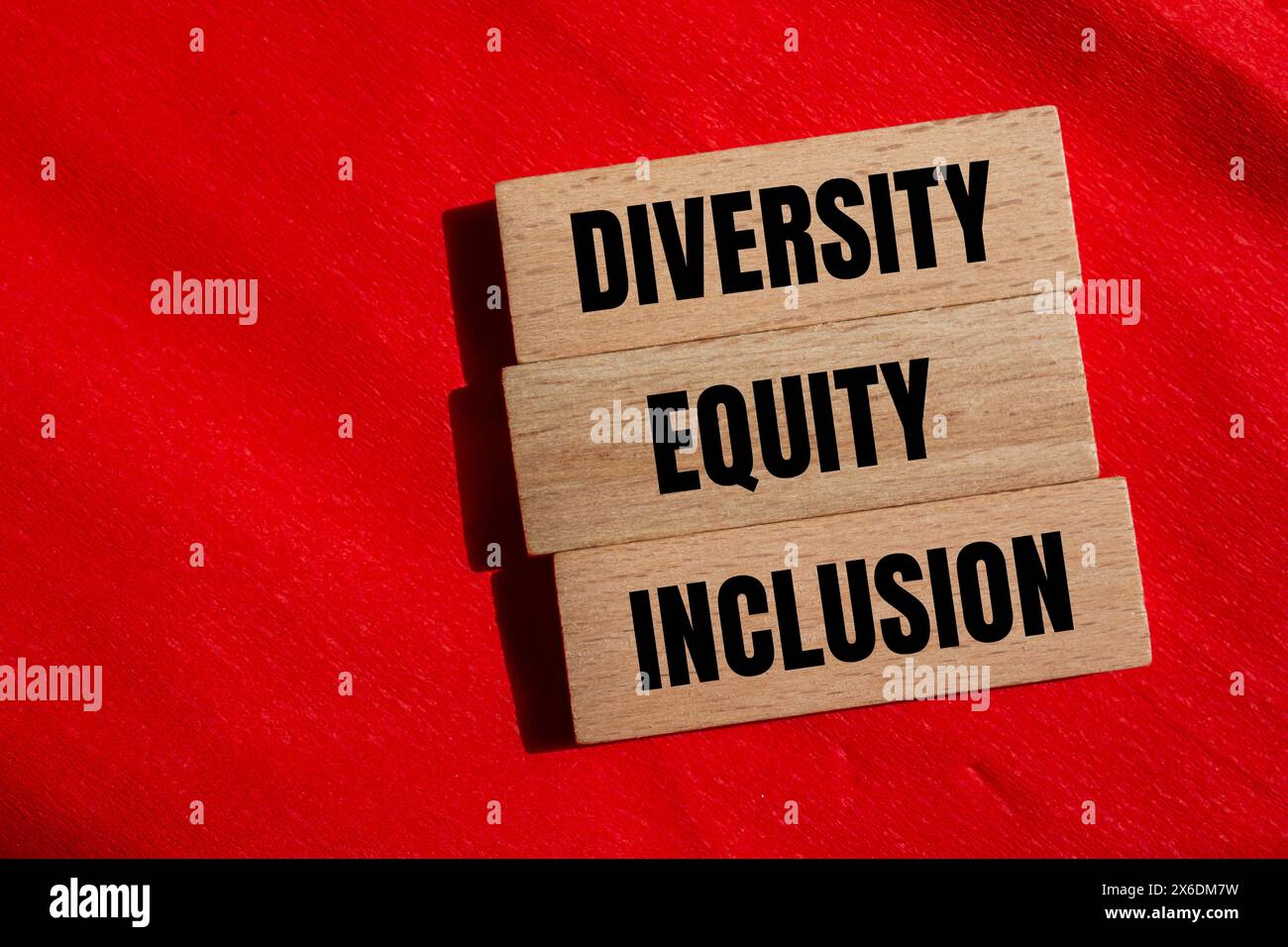 Diversity, equity and inclusion words written on wooden blocks with red ...