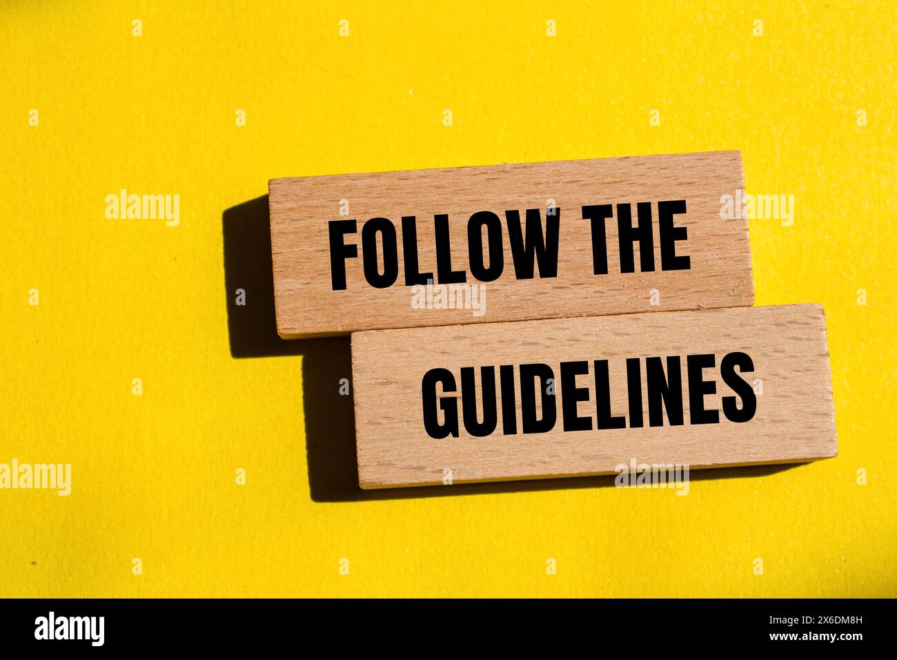 Follow the guidelines words written on wooden blocks with yellow ...