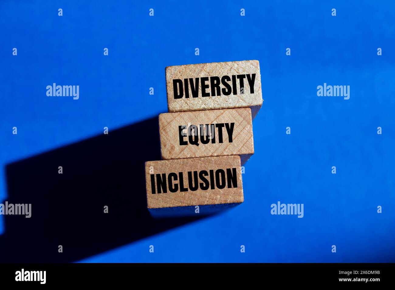 Diversity, equity and inclusion words written on wooden block with blue ...