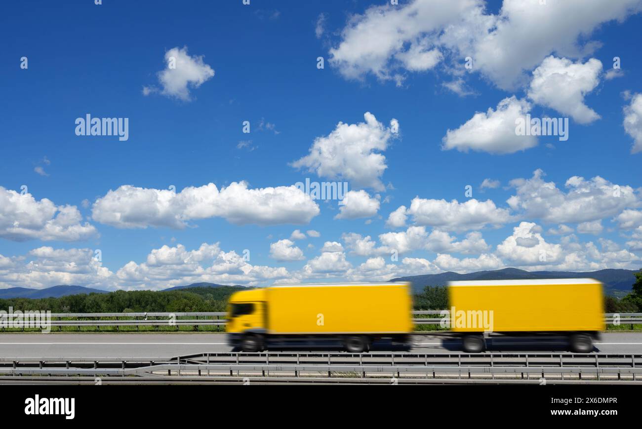 a yellow lorry with trailer drives on a motorway near Deggendorf, Lower ...