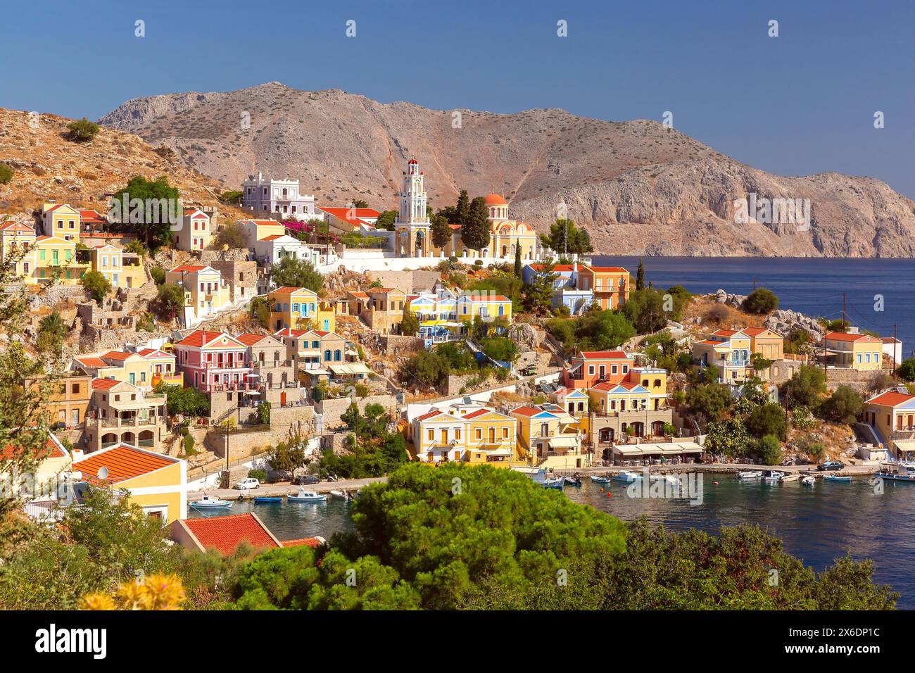 Wide panoramic shot of Symi Island with colorful houses against scenic ...