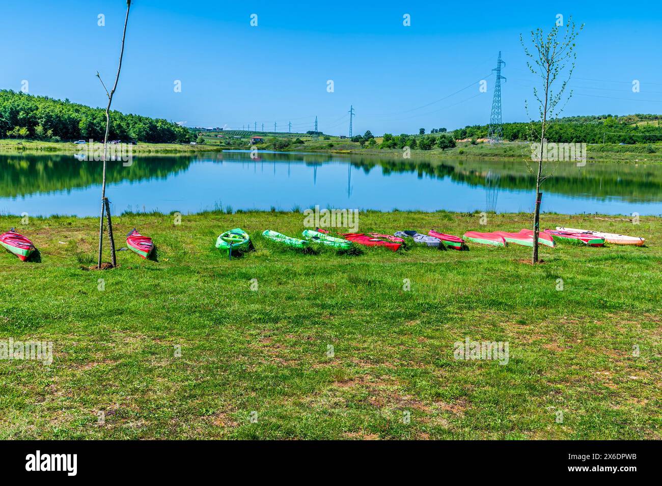 A view towards canoes on the shoreline of a lake at Belsh lakes in ...