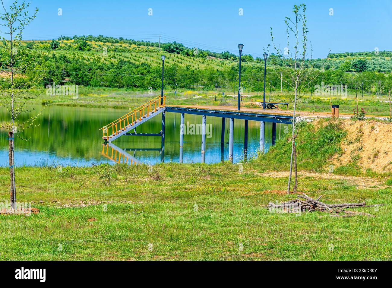 A view along a jetty on the shoreline of a lake at Belsh lakes in ...