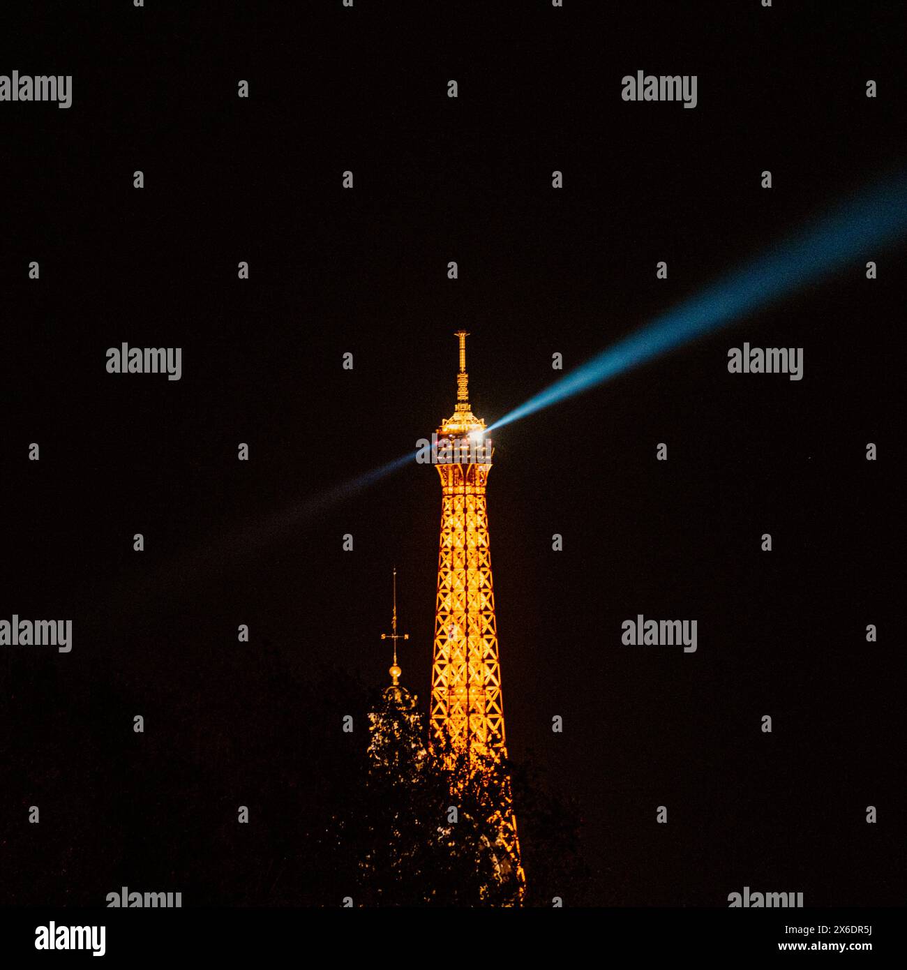 Illuminated Eiffel Tower with spotlight at night, Paris Stock Photo - Alamy