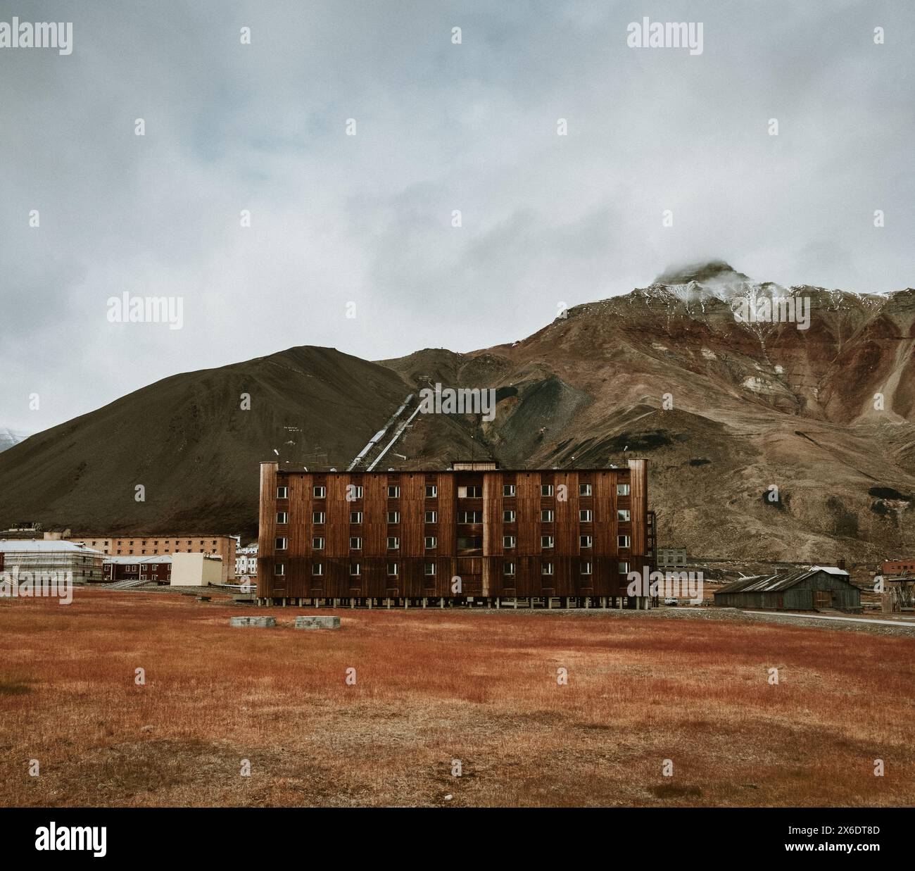 Large abandoned Soviet building in the stark landscape of Pyramiden ...