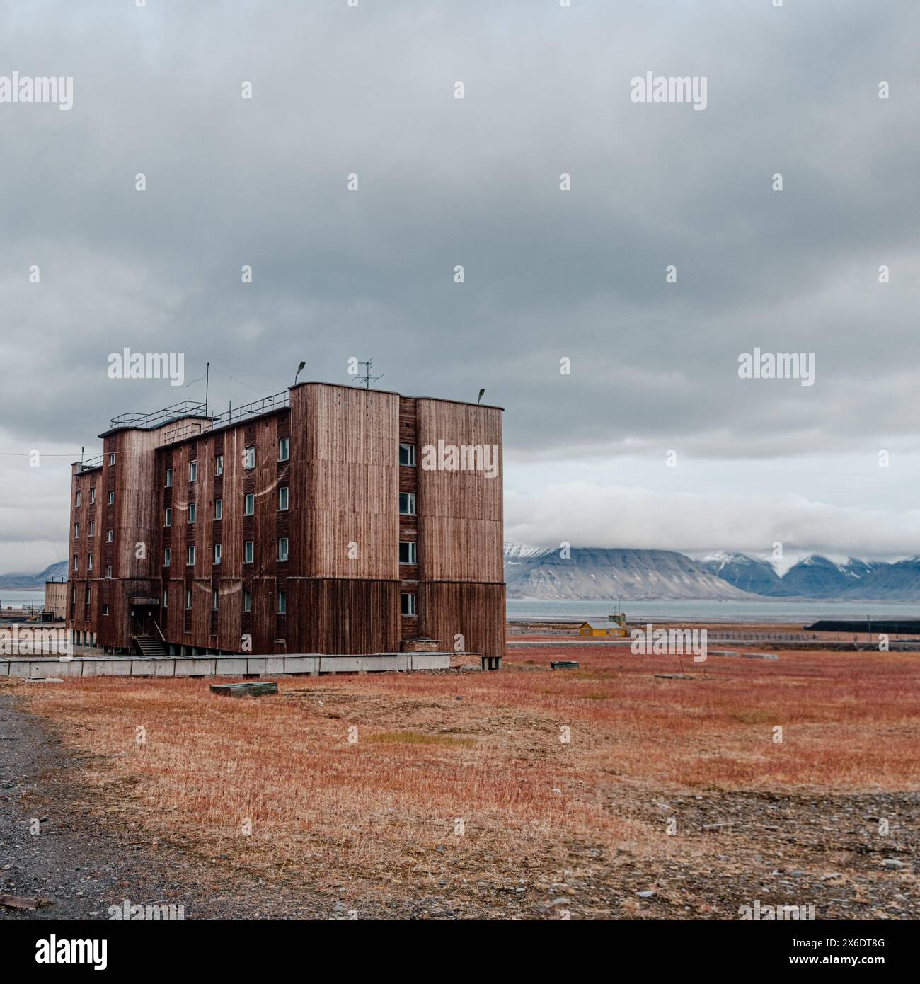 Large abandoned Soviet building in the stark landscape of Pyramiden ...