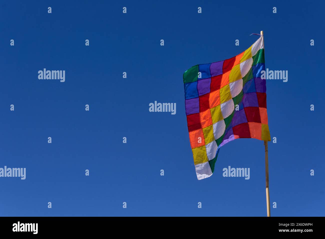 wiphala symbol flag flying on a background of clear blue sky in ...