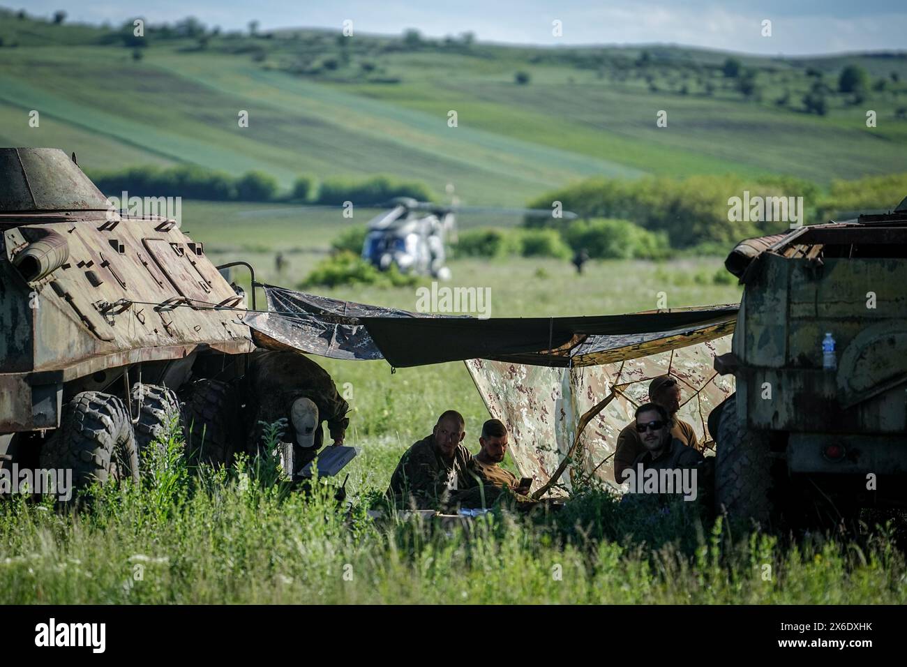 14 May 2024, Romania, Campia Turzii: Bundeswehr paratroopers rest ...