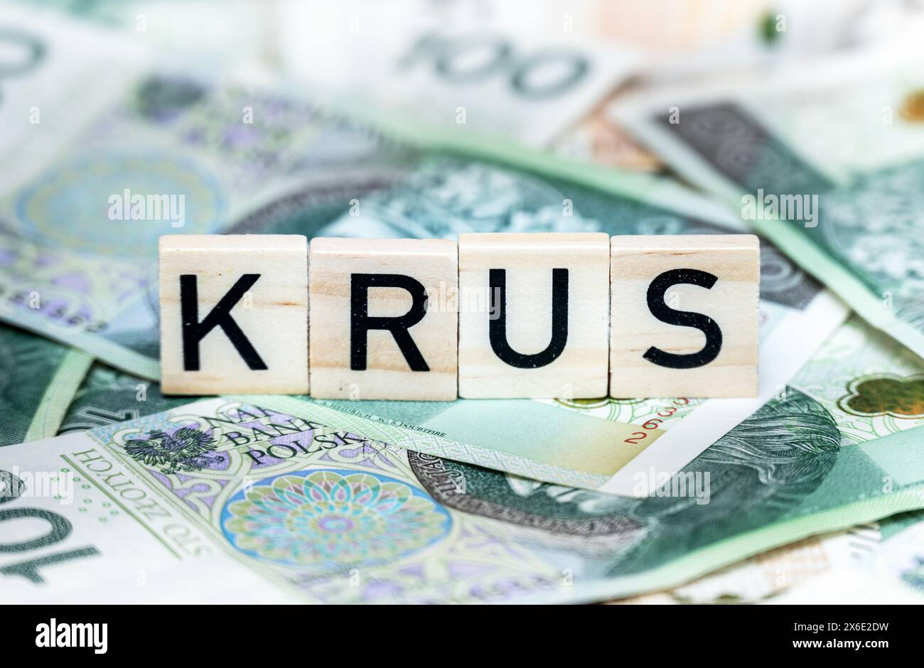 Close-up of Scrabble letters spelling "KRUS" arranged on a colourful ...