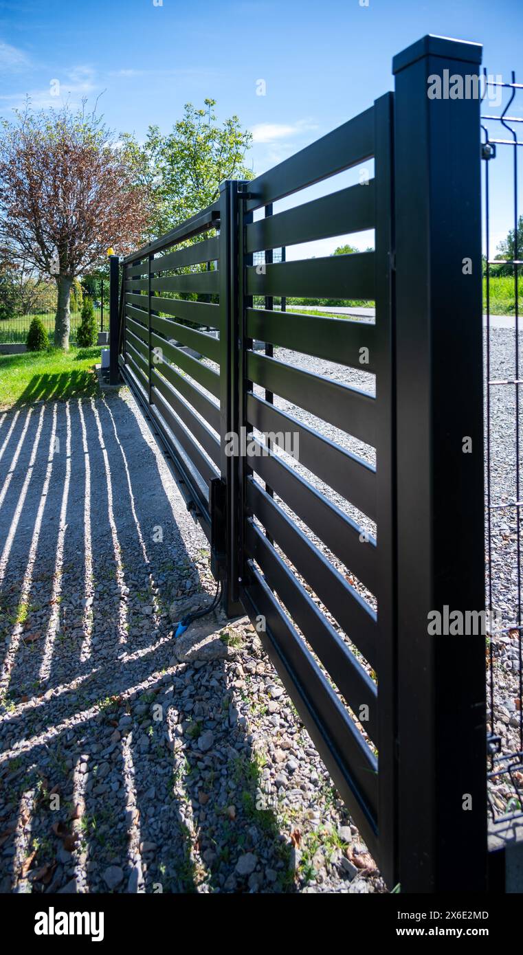 Modern black sliding gate at a residential entrance Stock Photo - Alamy