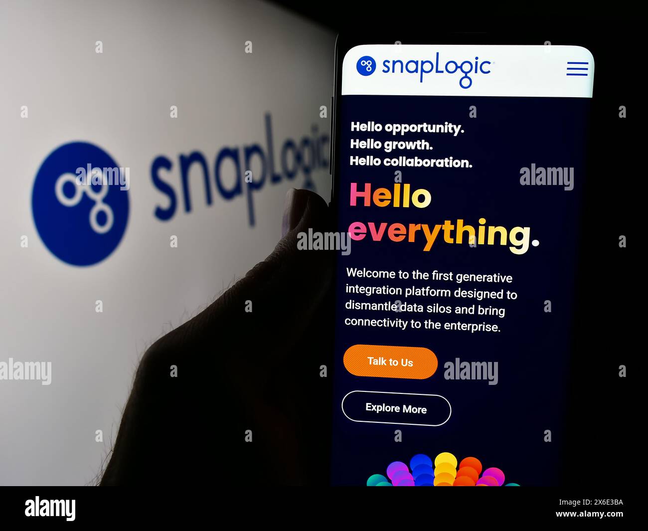 Person holding cellphone with webpage of US integration software ...