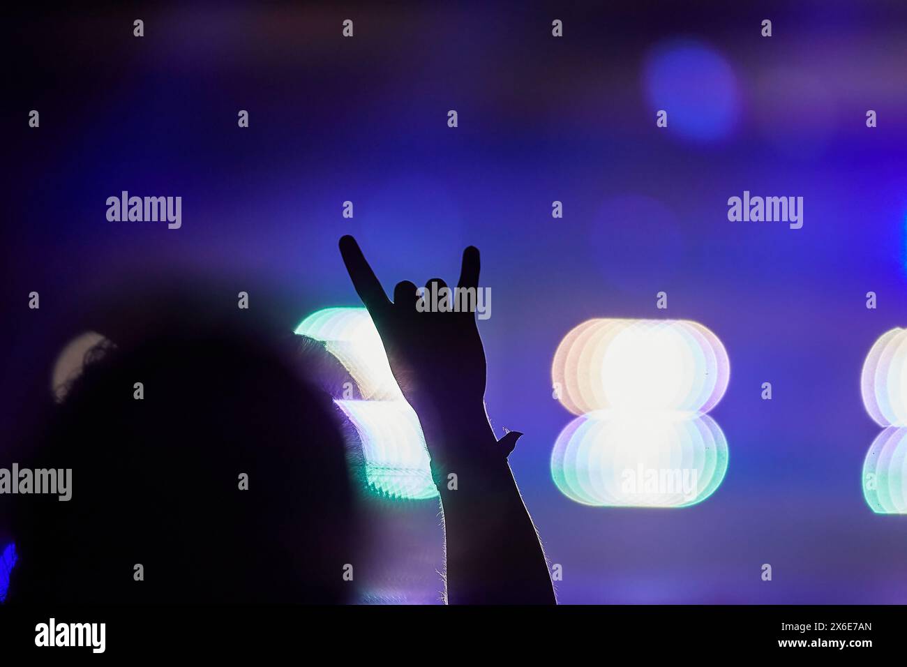 Concert audience sign of the horn, stage lights Stock Photo - Alamy