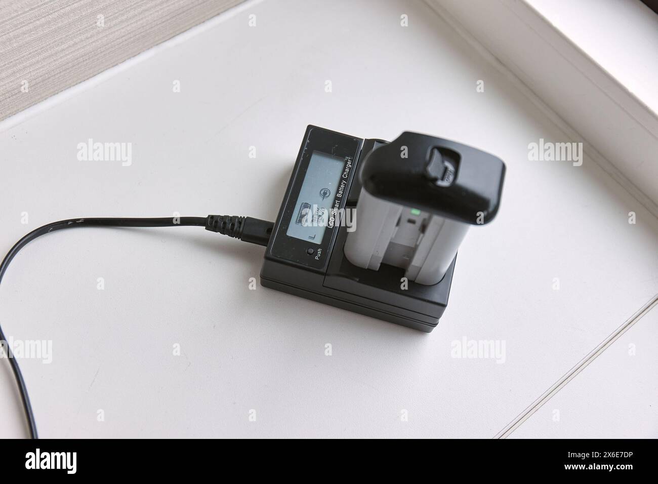 Camera battery charger recharging Stock Photo - Alamy