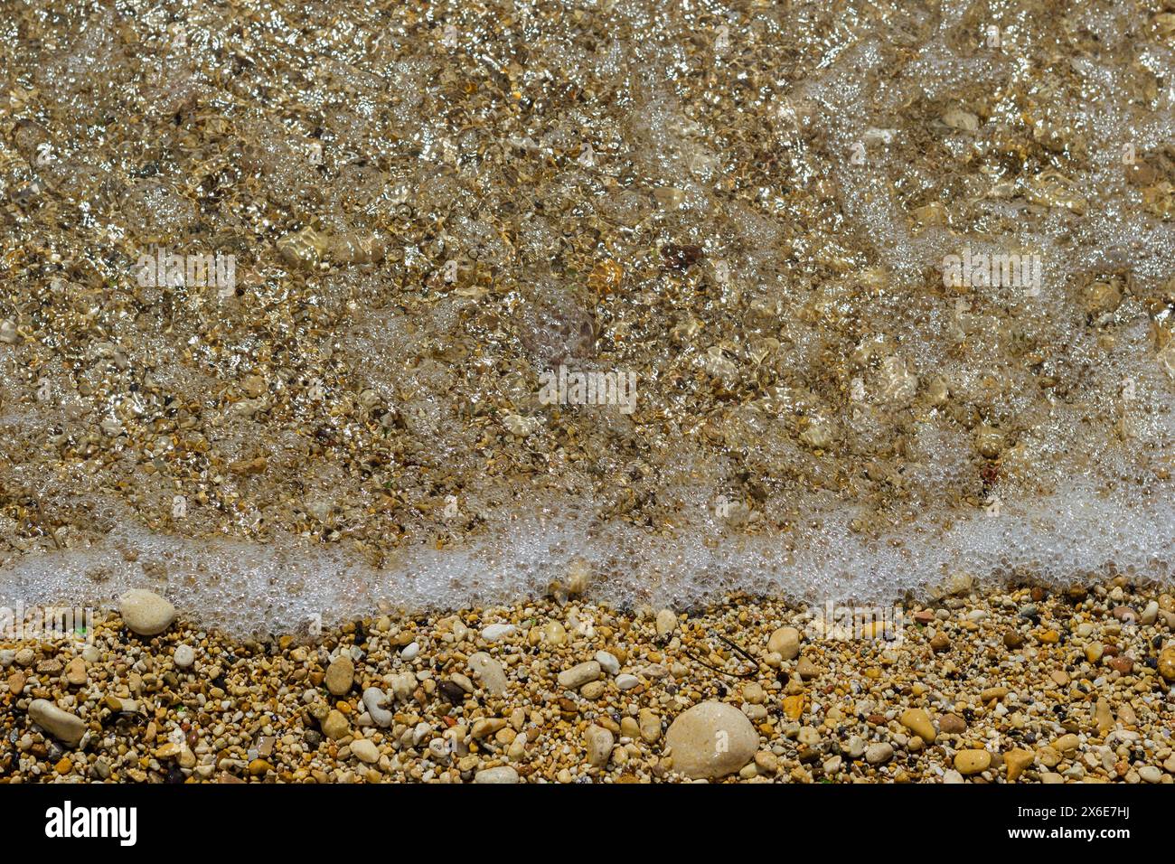 small stones on the beach with some waves of water Stock Photo - Alamy